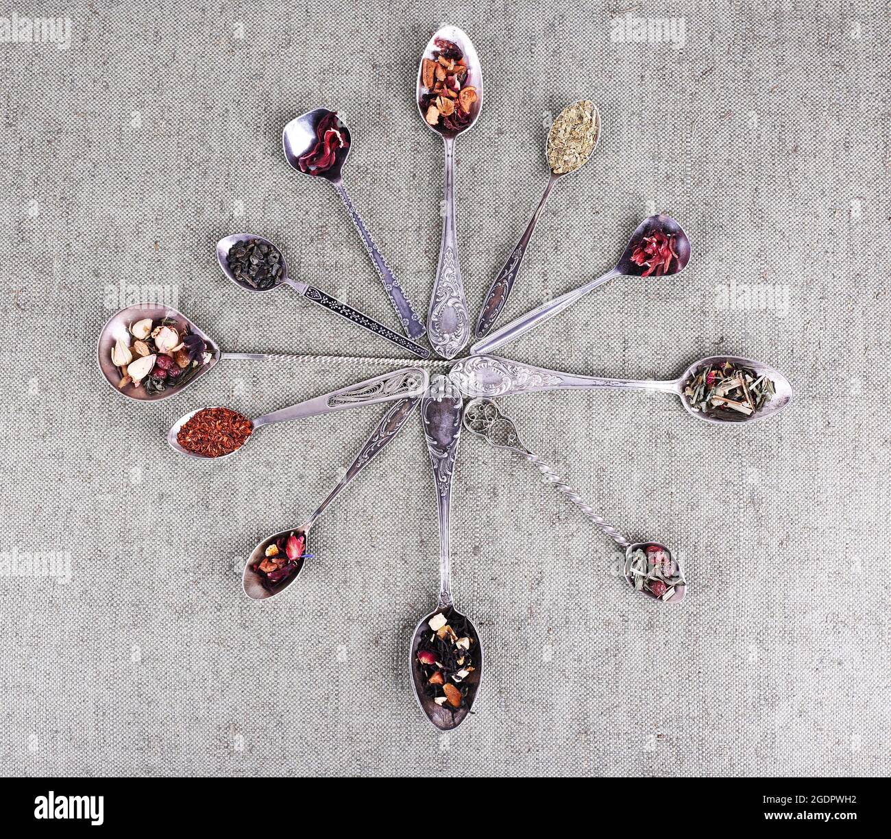 Tea in metal spoons on grey fabric background Stock Photo - Alamy