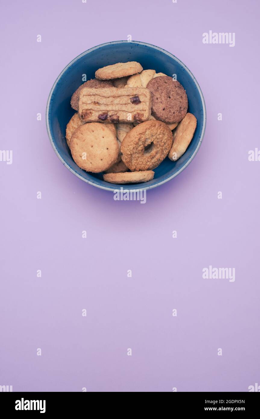 Vertical shot of sweets on a purple background Stock Photo - Alamy