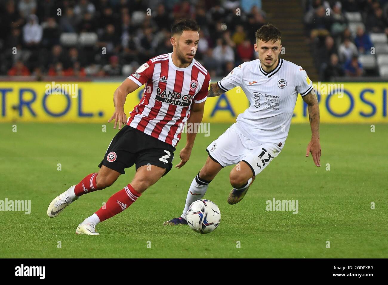 George Baldock #2 of Sheffield United takes on Jamie Paterson #12 of ...