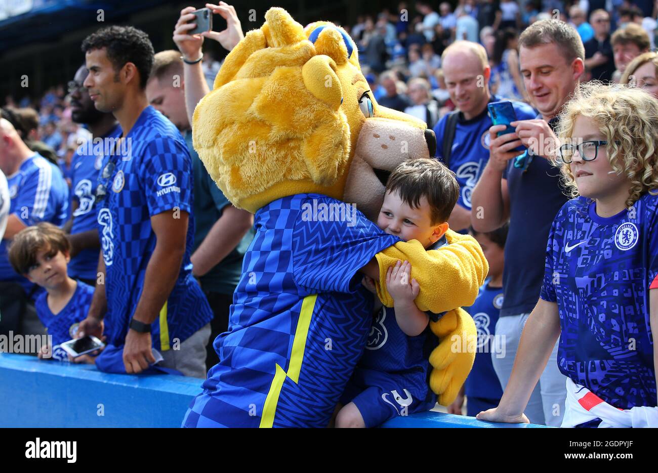 London, England, 14th August 2021. The Chelsea mascot hugs a young fan ...