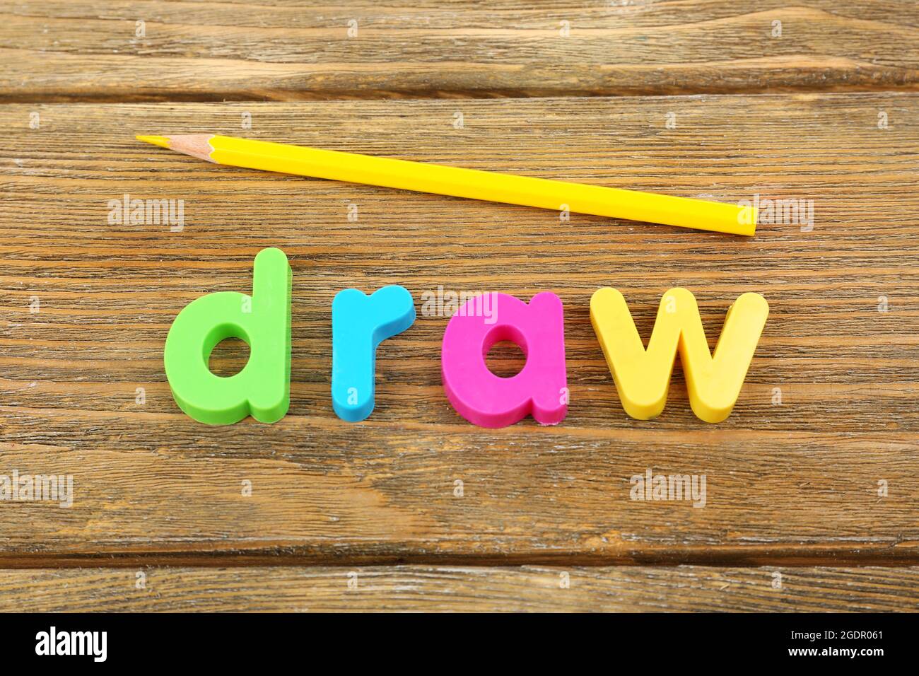 Draw word formed with colorful letters on wooden background Stock Photo ...