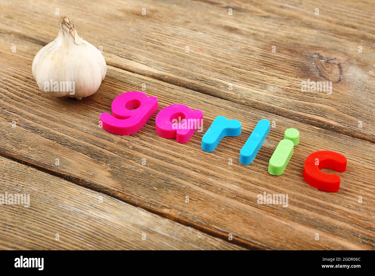Garlic word formed with colorful letters on wooden background Stock ...