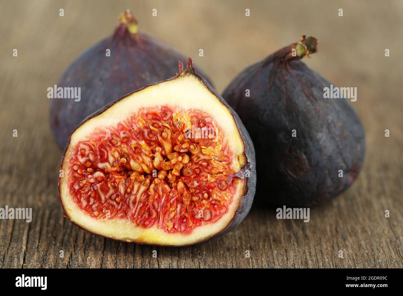 Ripe sweet figs on wooden background Stock Photo - Alamy