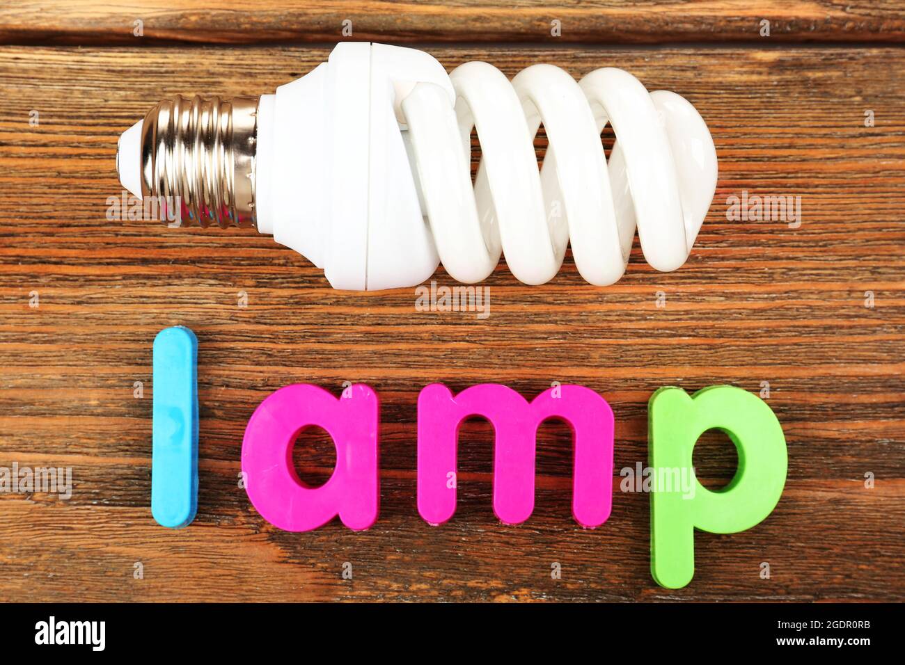 Lamp word formed with colorful letters on wooden background Stock Photo ...