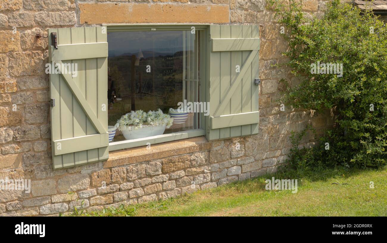 Looking at a window from outside with green shutters Stock Photo - Alamy