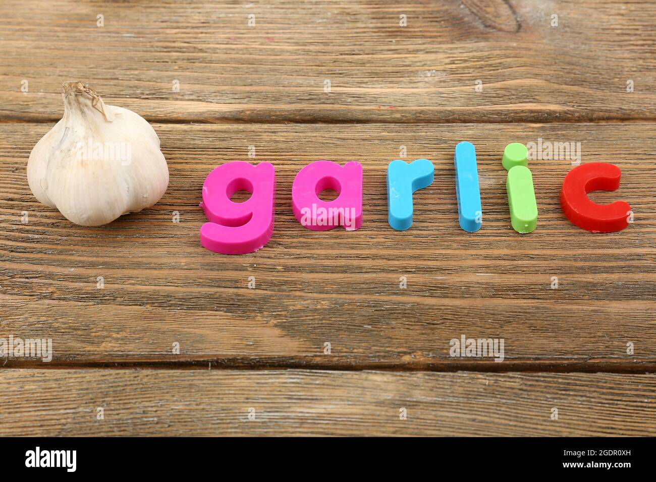 Garlic word formed with colorful letters on wooden background Stock ...