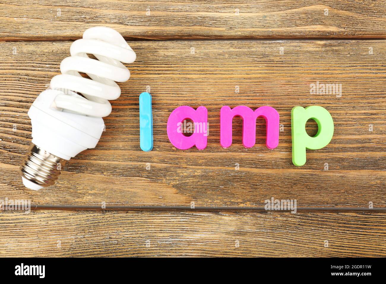 Lamp word formed with colorful letters on wooden background Stock Photo ...