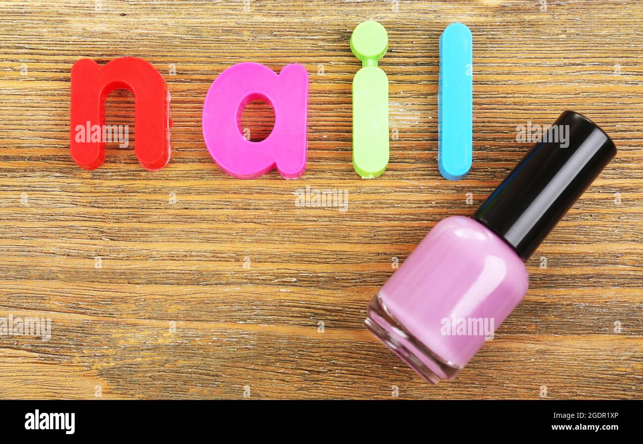 Nail word formed with colorful letters on wooden background Stock Photo ...