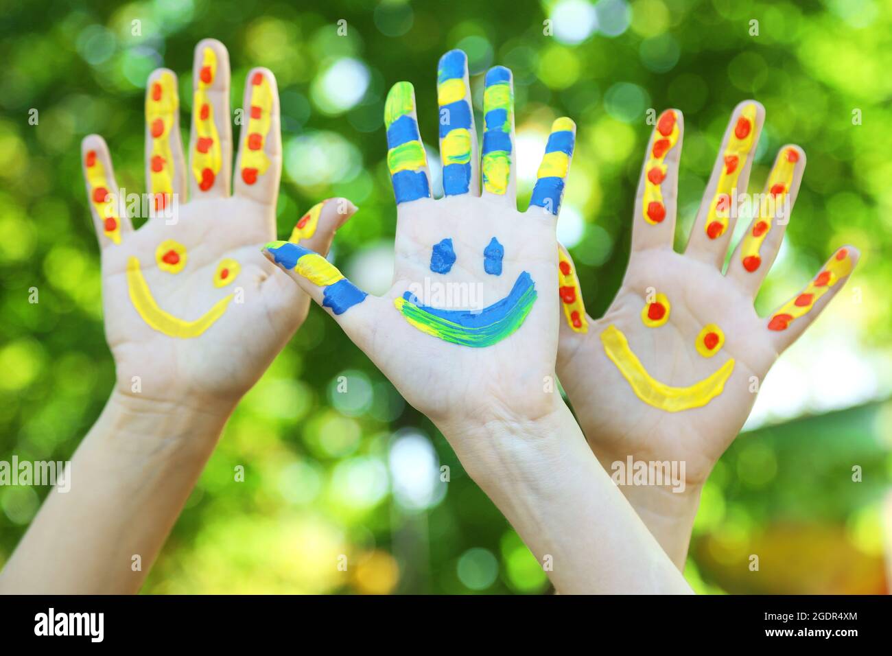 Smiling colorful hands on natural background Stock Photo - Alamy