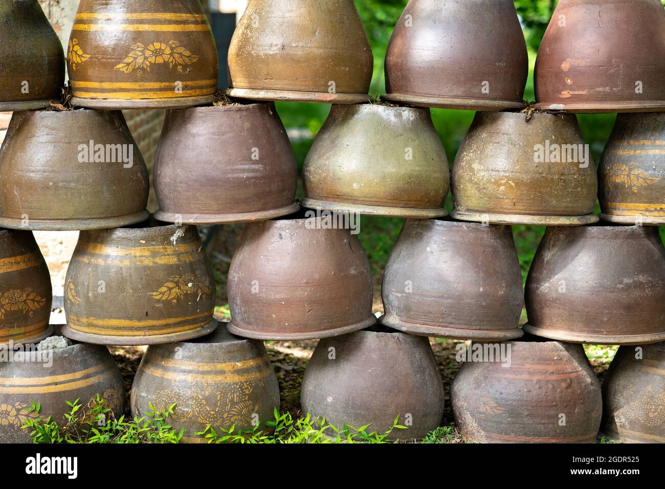 Shot of old clay inverted pots sorted on each other in the garden Stock ...