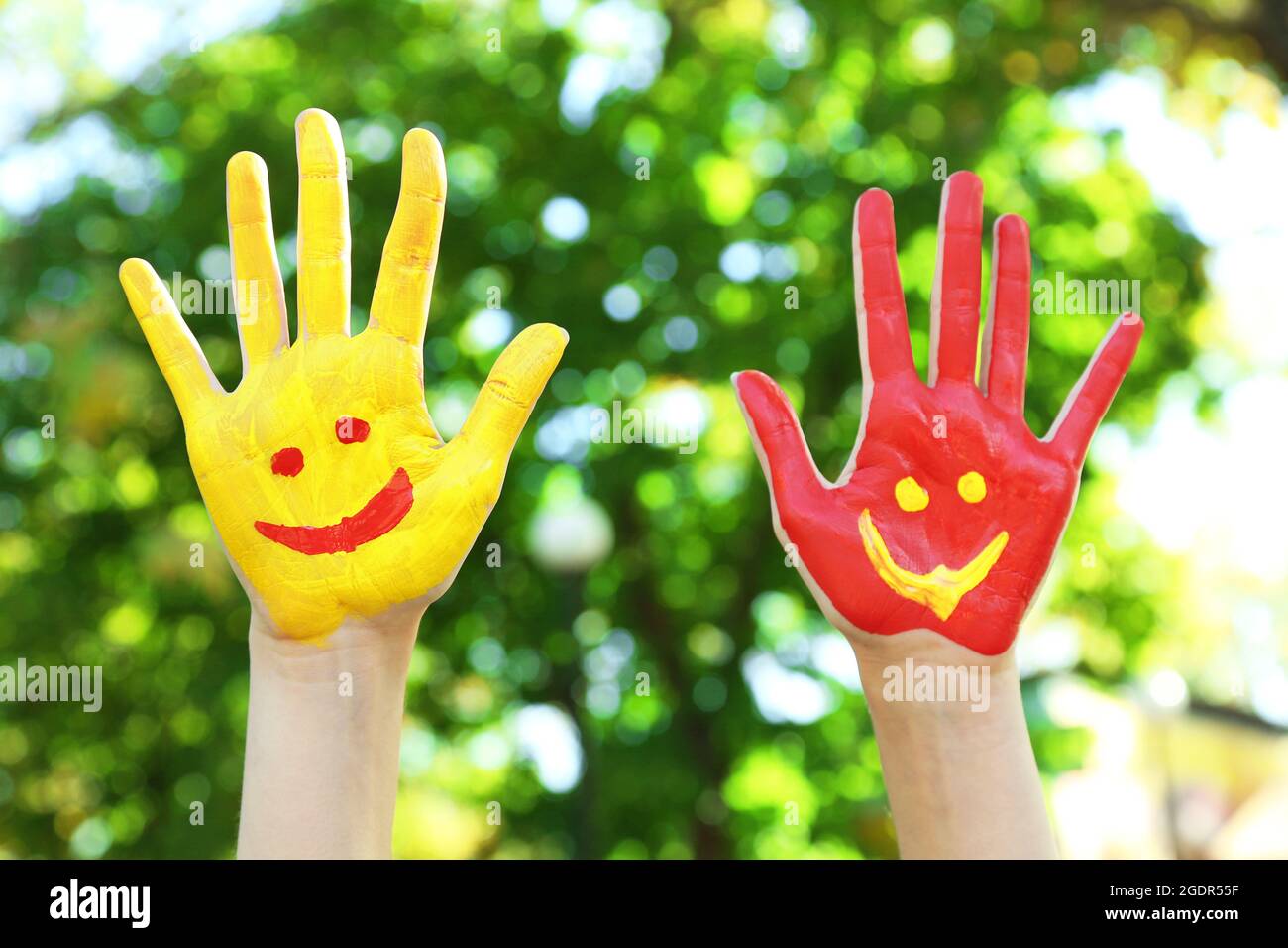 Smiling colorful hands on natural background Stock Photo - Alamy