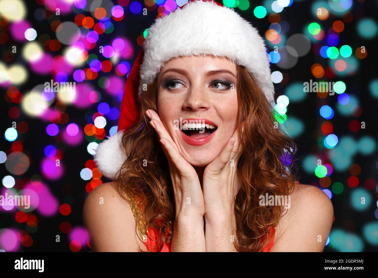 Portrait of beautiful young woman on bright lights background Stock ...