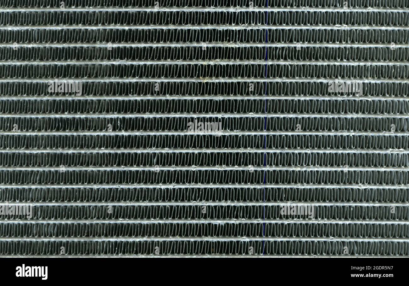 the aluminium ribs on a small cooling unit create an industrial ...