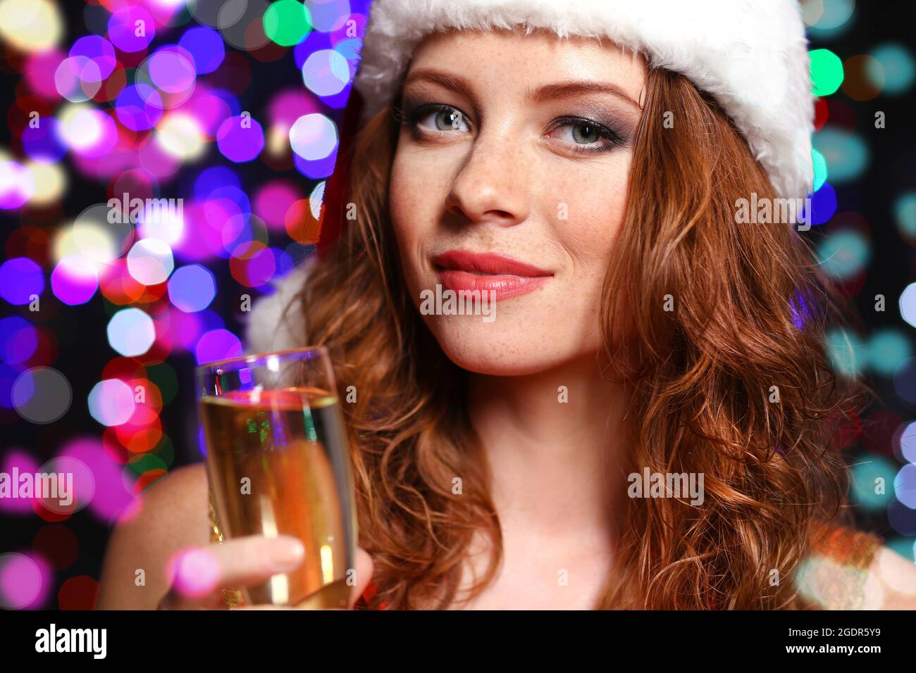 Portrait of beautiful young woman on bright lights background Stock ...