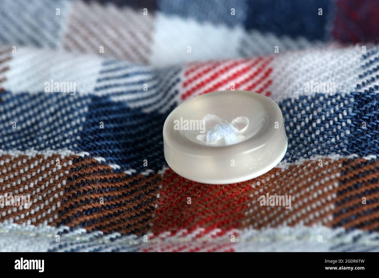 Button on clothes close up Stock Photo - Alamy