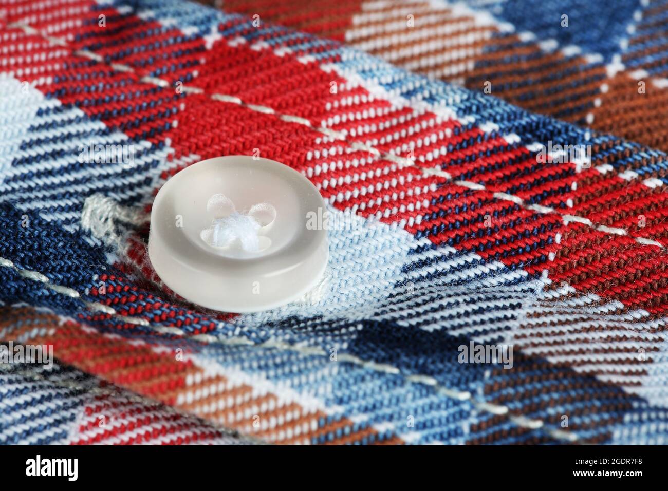 Button on clothes close up Stock Photo - Alamy