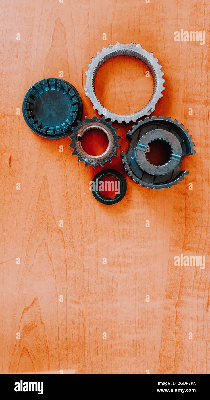 Vertical top view of metal gears on a wooden surface Stock Photo - Alamy