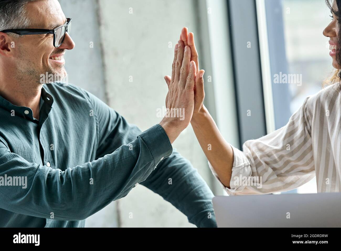 Two happy diverse colleagues business people giving high five at ...