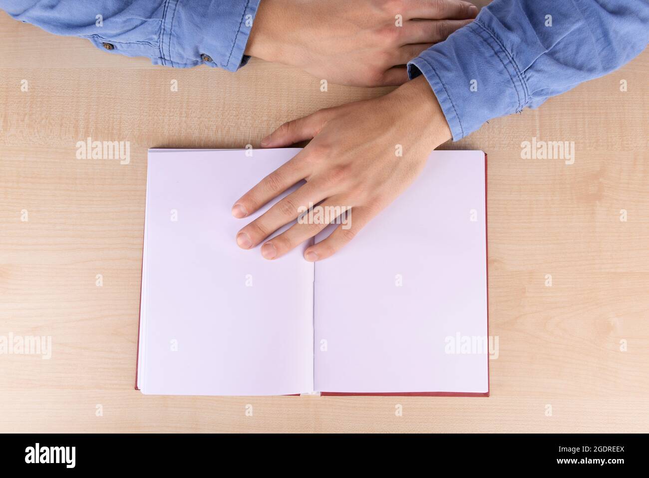 Men reading empty open book on wooden table background Stock Photo - Alamy