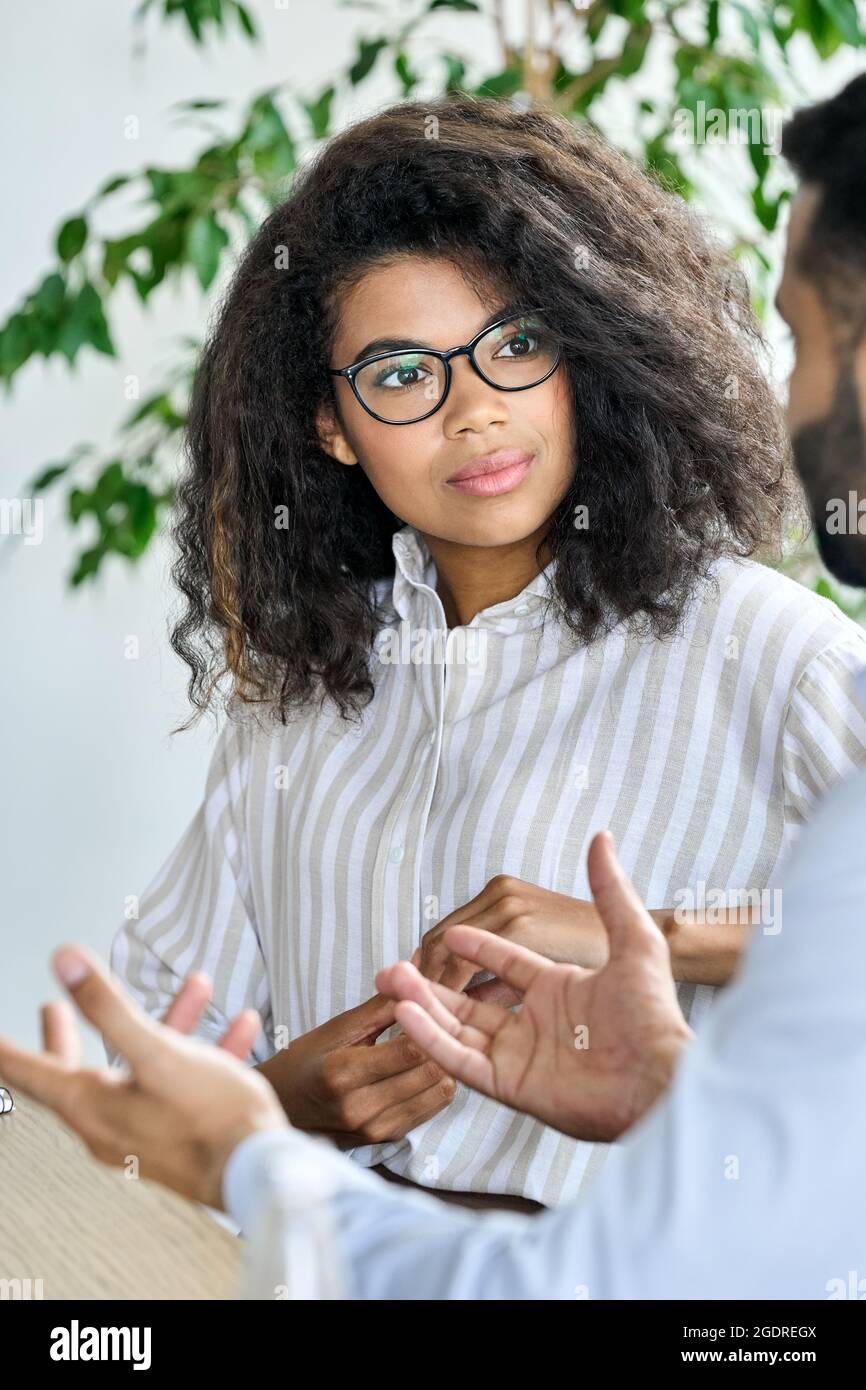 Female African American manager listening to Indian ceo mentor leader ...