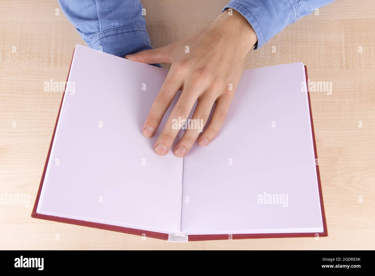 Men reading empty open book on wooden table background Stock Photo - Alamy