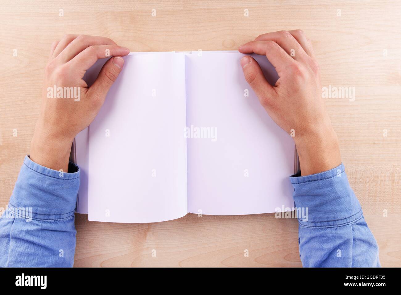 Men reading empty open book on wooden table background Stock Photo - Alamy