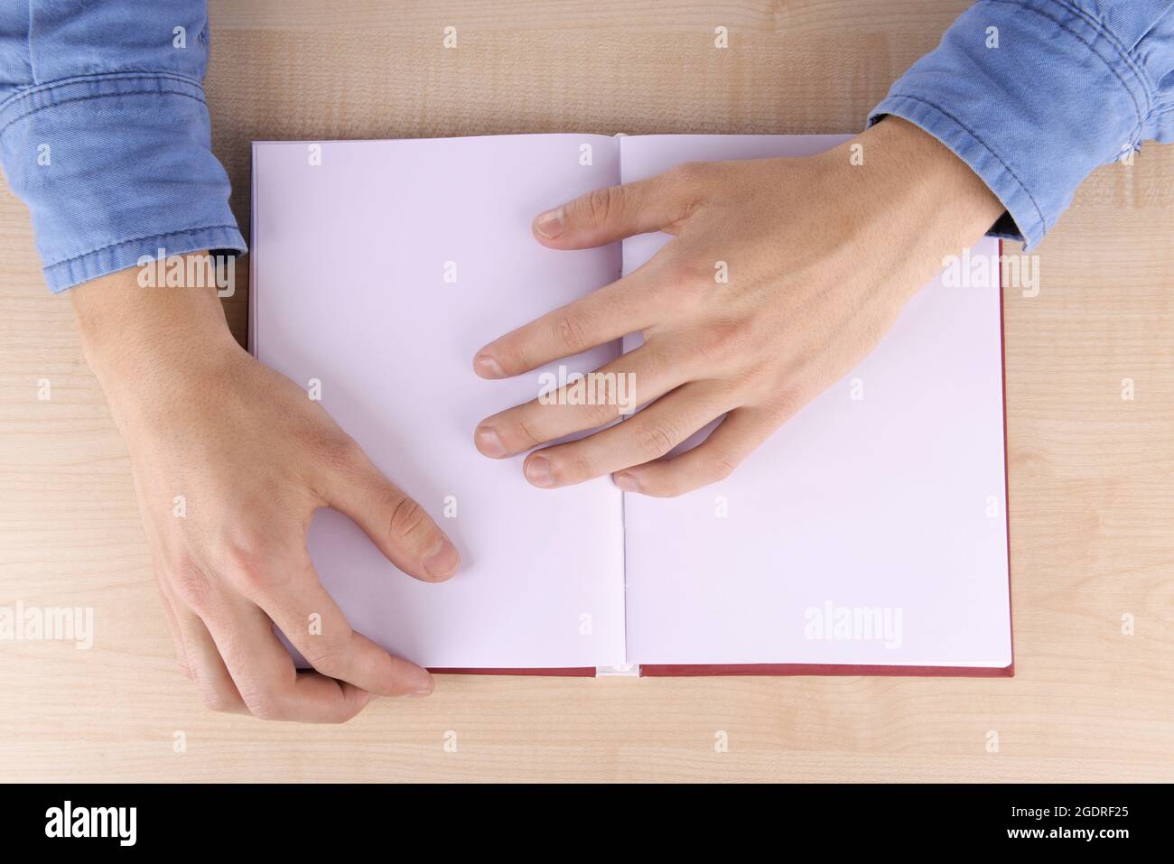 Men reading empty open book on wooden table background Stock Photo - Alamy
