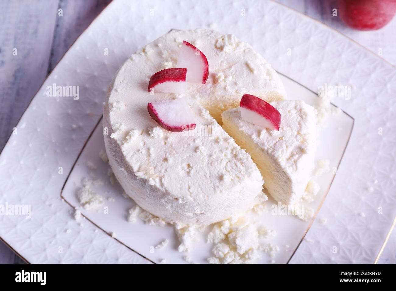 Cottage cheese on plate and radish on wooden background Stock Photo - Alamy