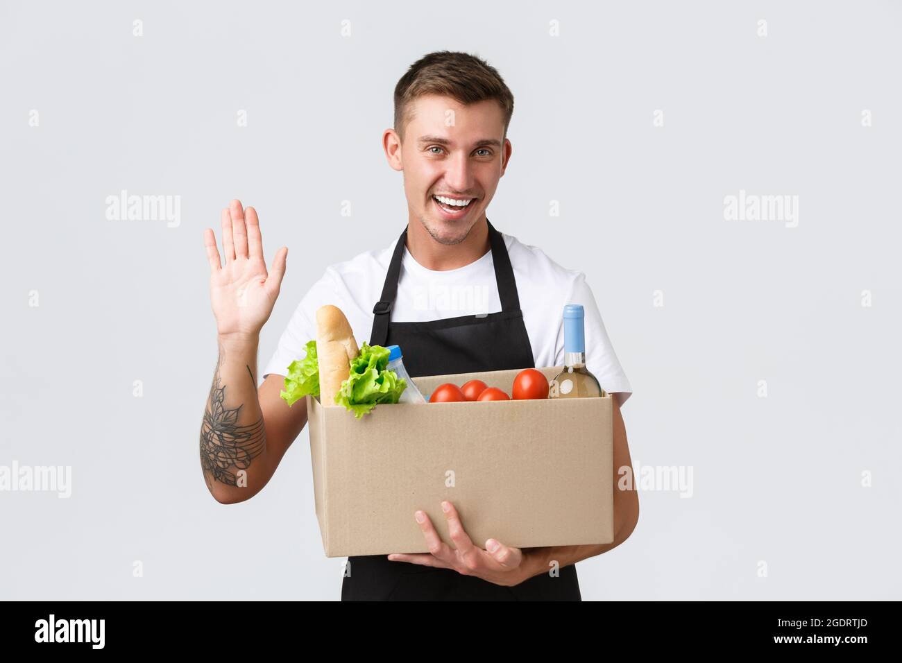 Retail, grocery shopping and delivery concept. Friendly handsome ...