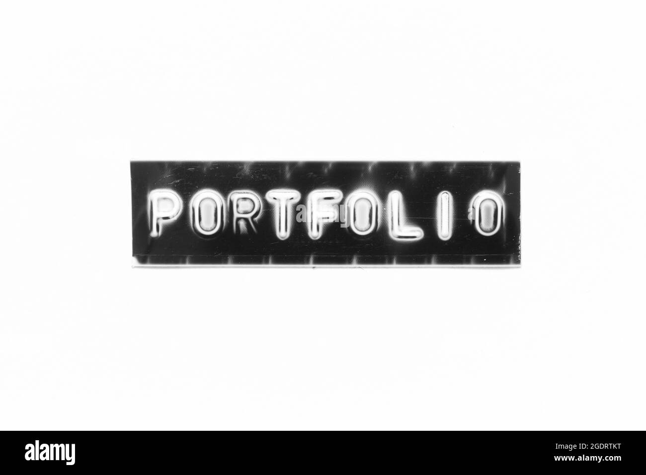 Embossed letter with word portfolio in black banner on white paper ...