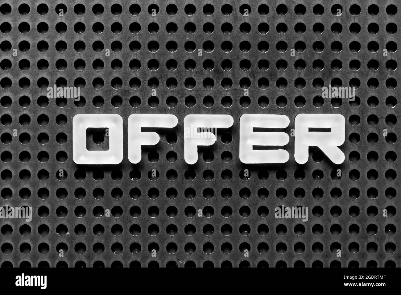 White alphabet letter in word offer on black pegboard background Stock ...