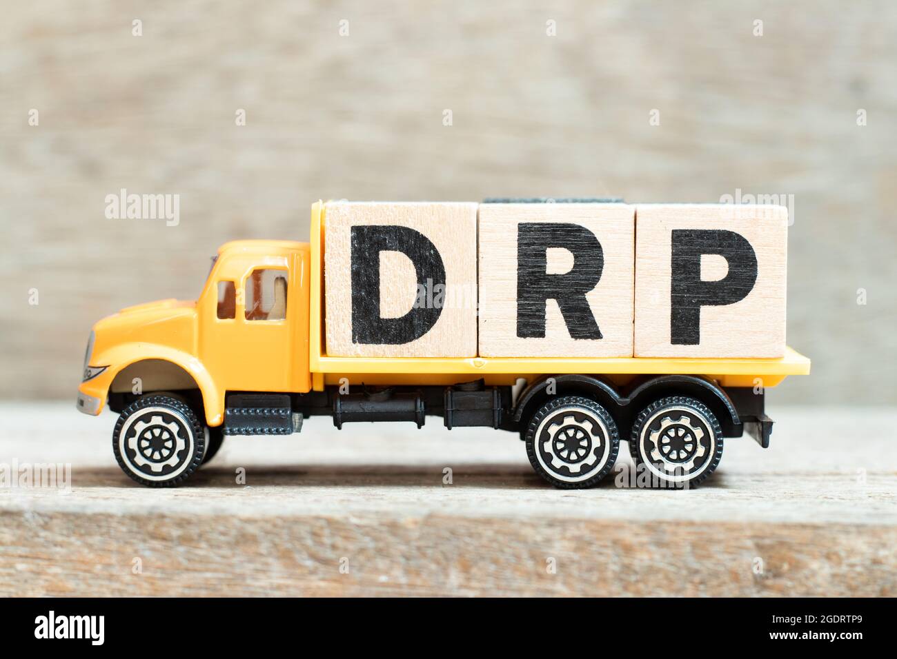Toy truck hold alphabet letter block in word DRP (Abbreviation of ...