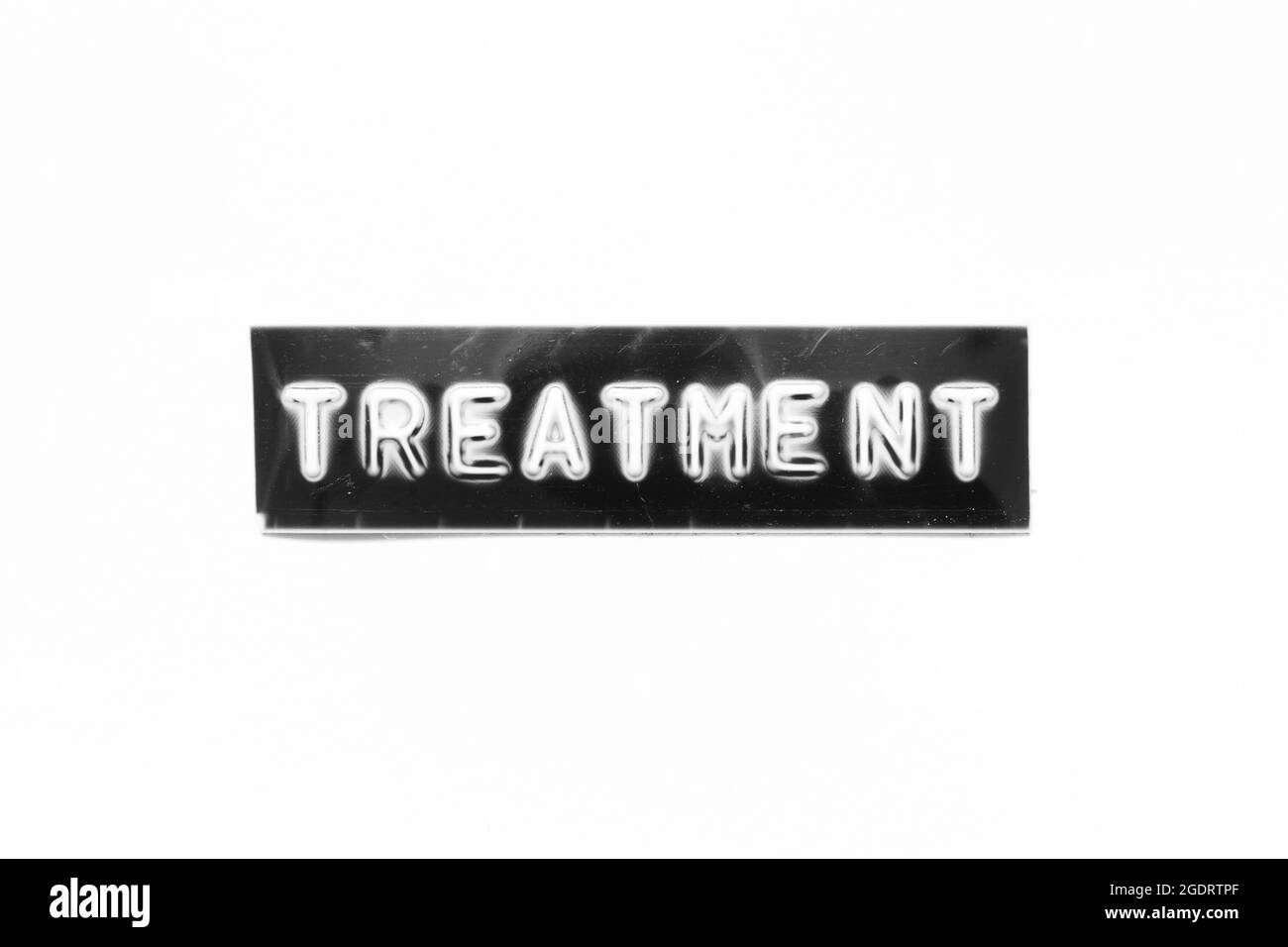 Embossed letter with word treatment in black banner on white paper ...