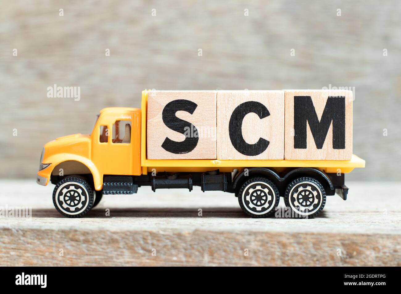 Toy truck hold alphabet letter block in word SCM (Abbreviation of ...