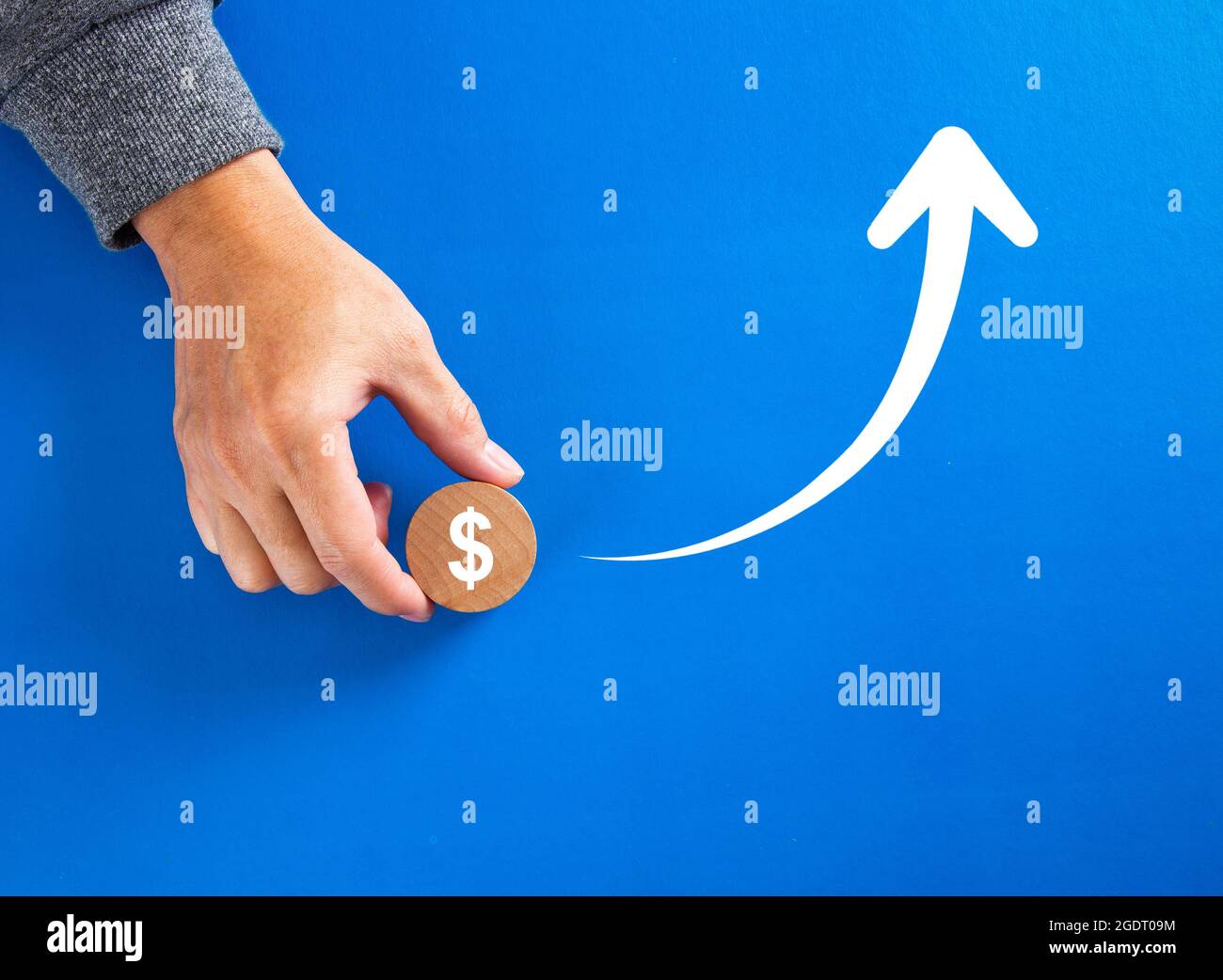 Hand with Dollar Sign on wooden block and arrow growth upward. Copy ...