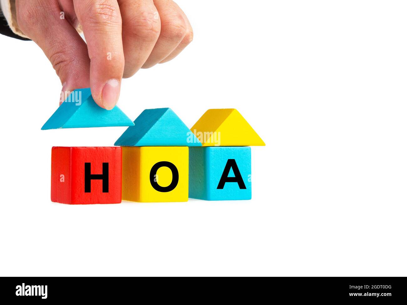 Businessperson's hand placing wooden house block with HOA word isolated ...