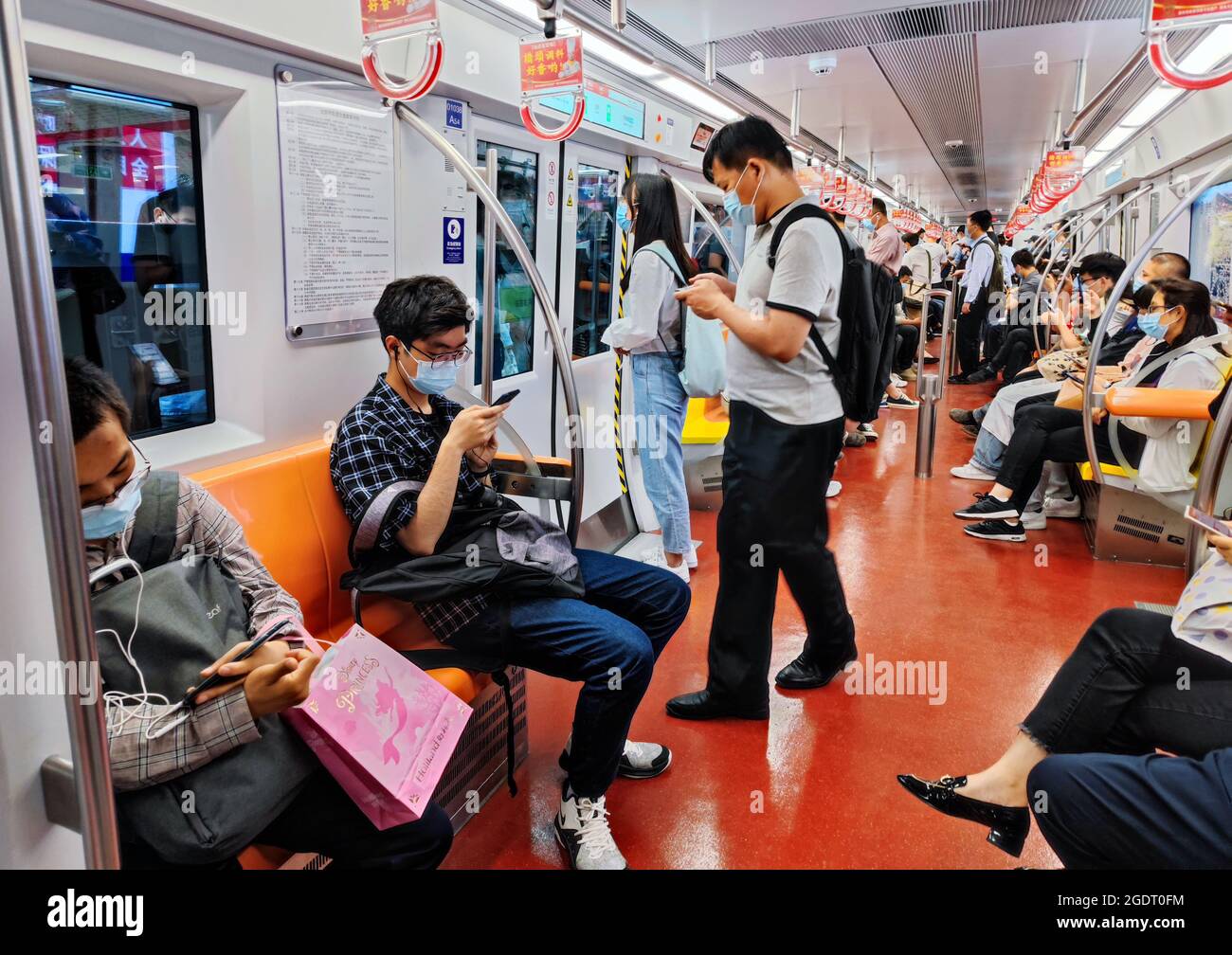 BEIJING, CHINA - AUGUST 13, 2021 - Passengers wearing face masks are ...