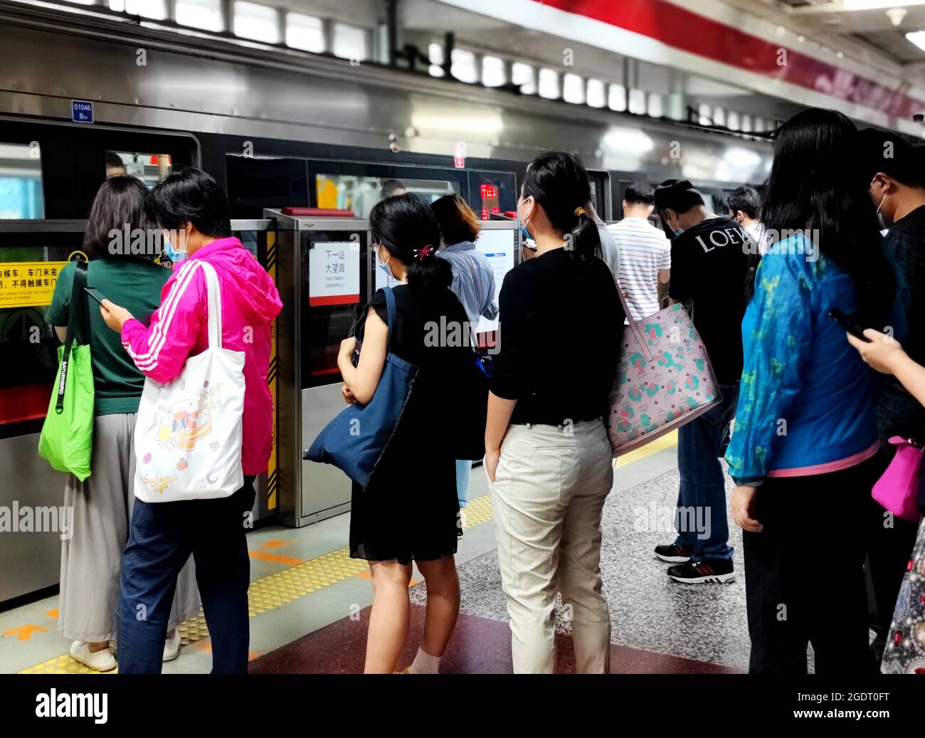 BEIJING, CHINA - AUGUST 13, 2021 - Passengers wearing face masks are ...