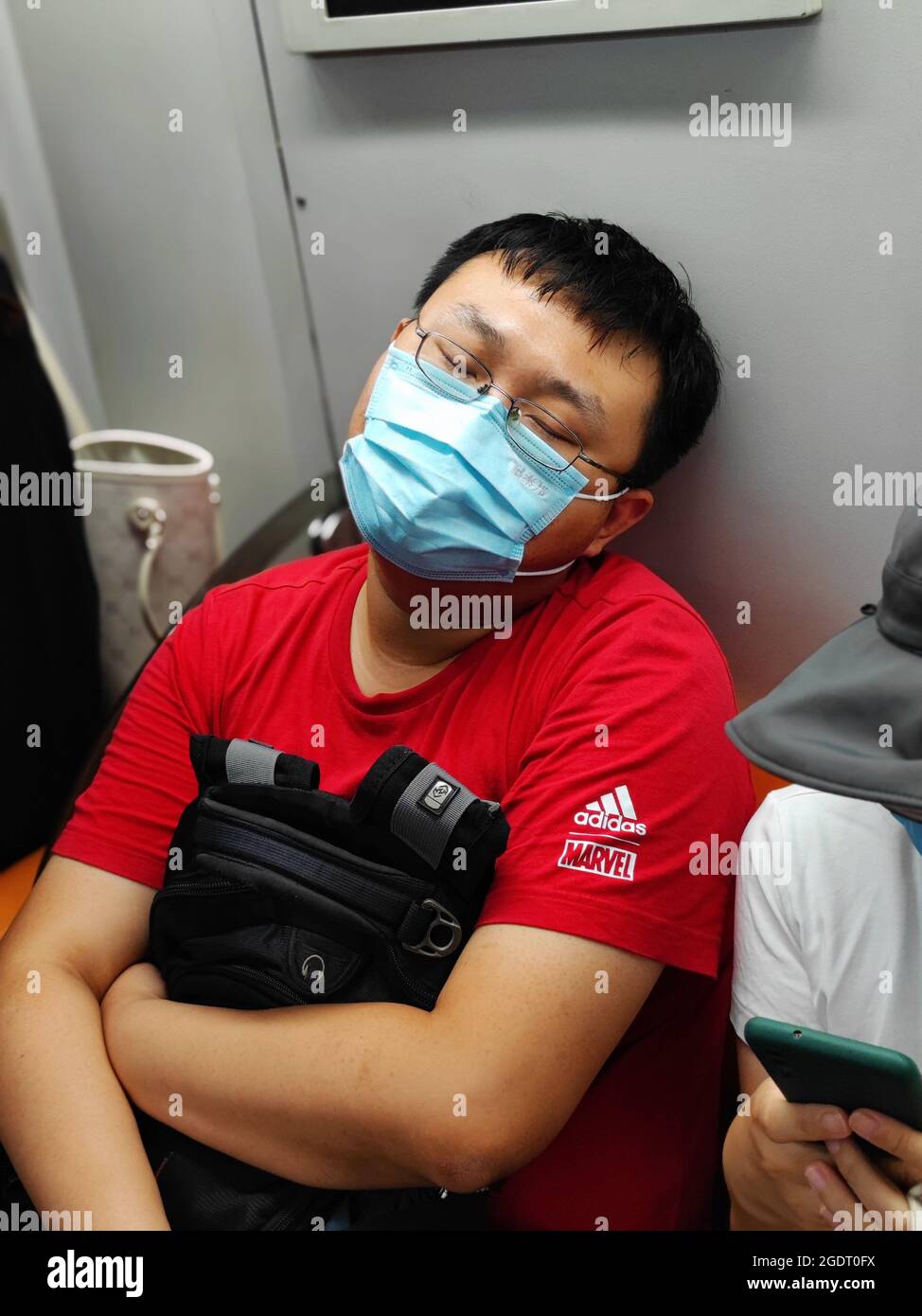 BEIJING, CHINA - AUGUST 13, 2021 - Passengers wearing face masks are ...