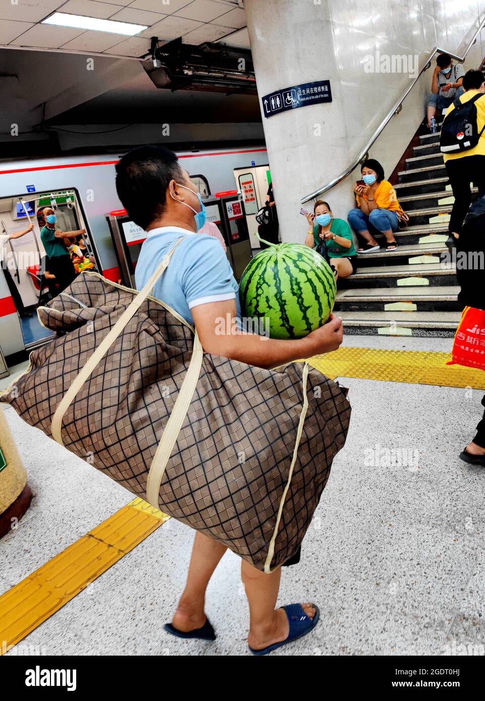 BEIJING, CHINA - AUGUST 13, 2021 - Passengers wearing face masks are ...