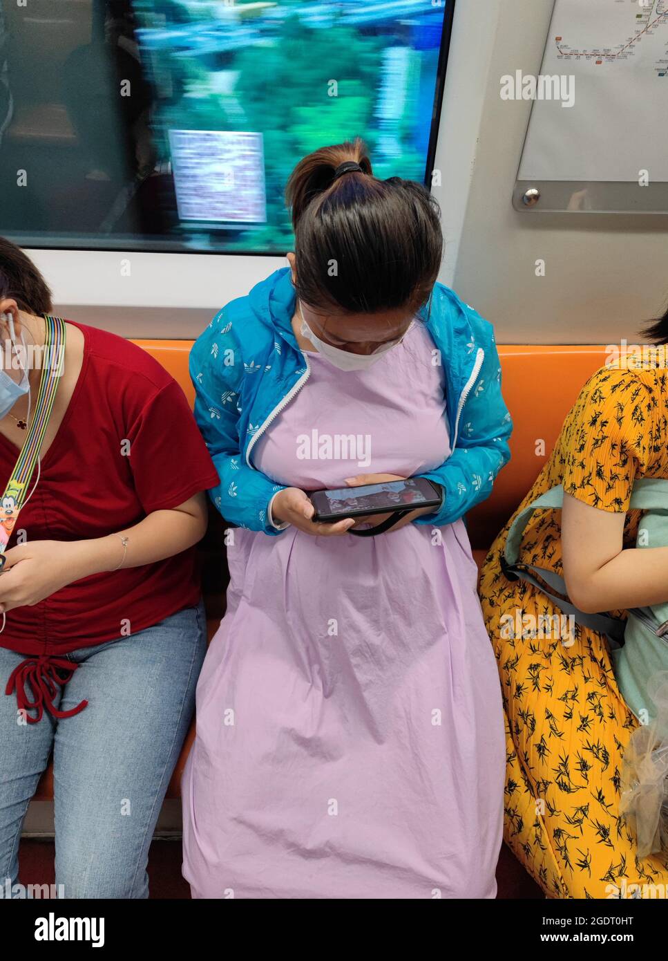 BEIJING, CHINA - AUGUST 13, 2021 - Passengers wearing face masks are ...