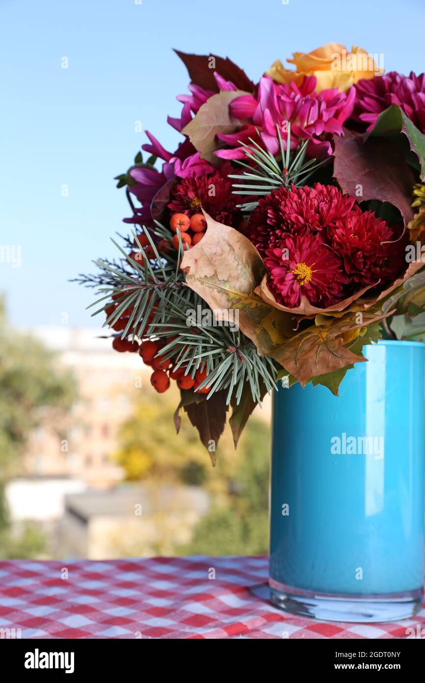 Flower bouquet in blue vase on table on natural background Stock Photo ...