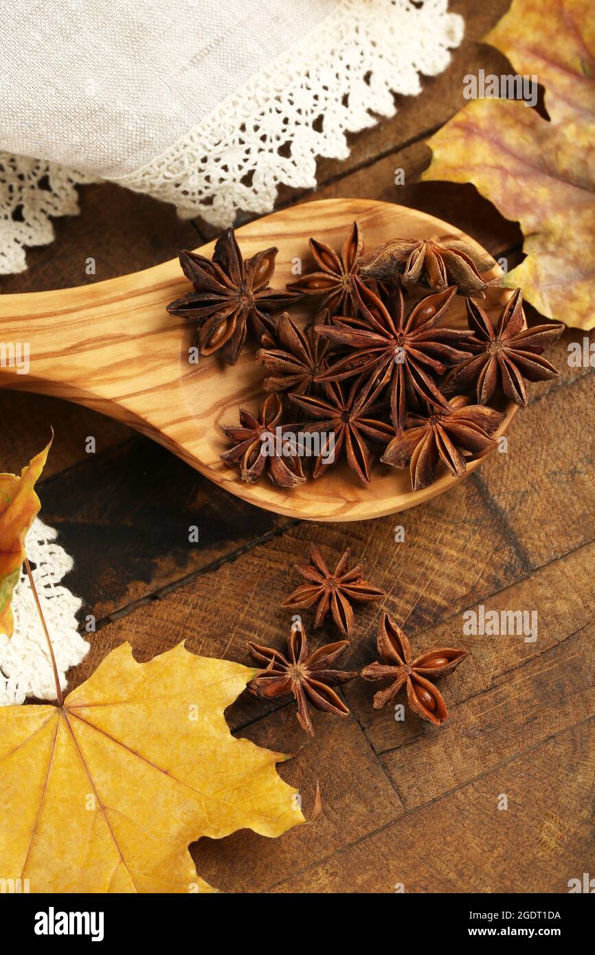 Stars anise in wooden spoon on table close up Stock Photo - Alamy