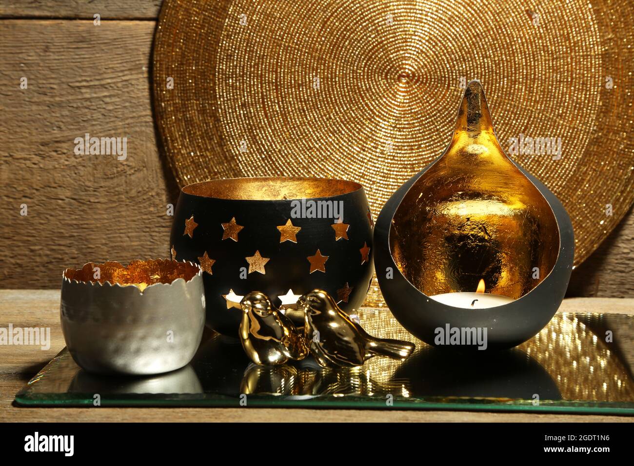 Beautiful candlesticks and other decorations for home interior on dark ...