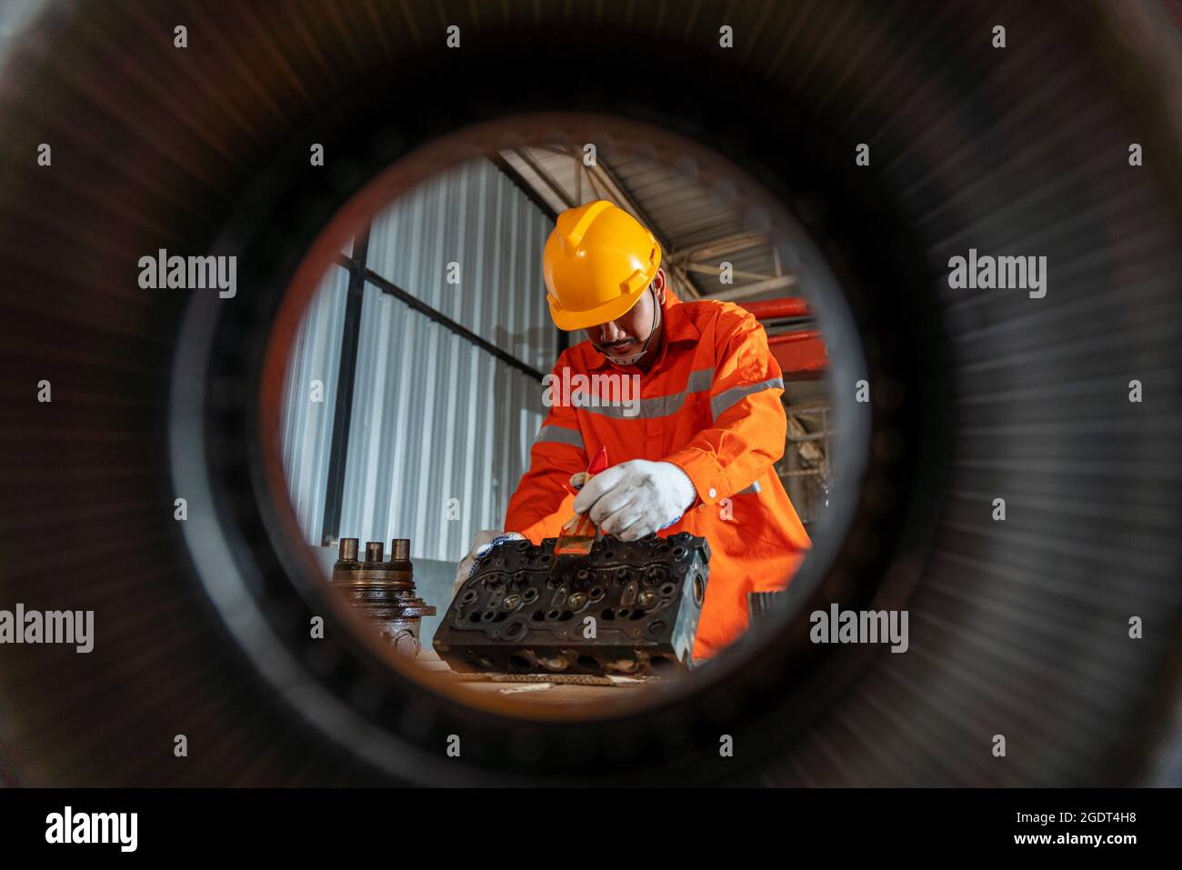 An excavator repair technician working inspection and repair ...