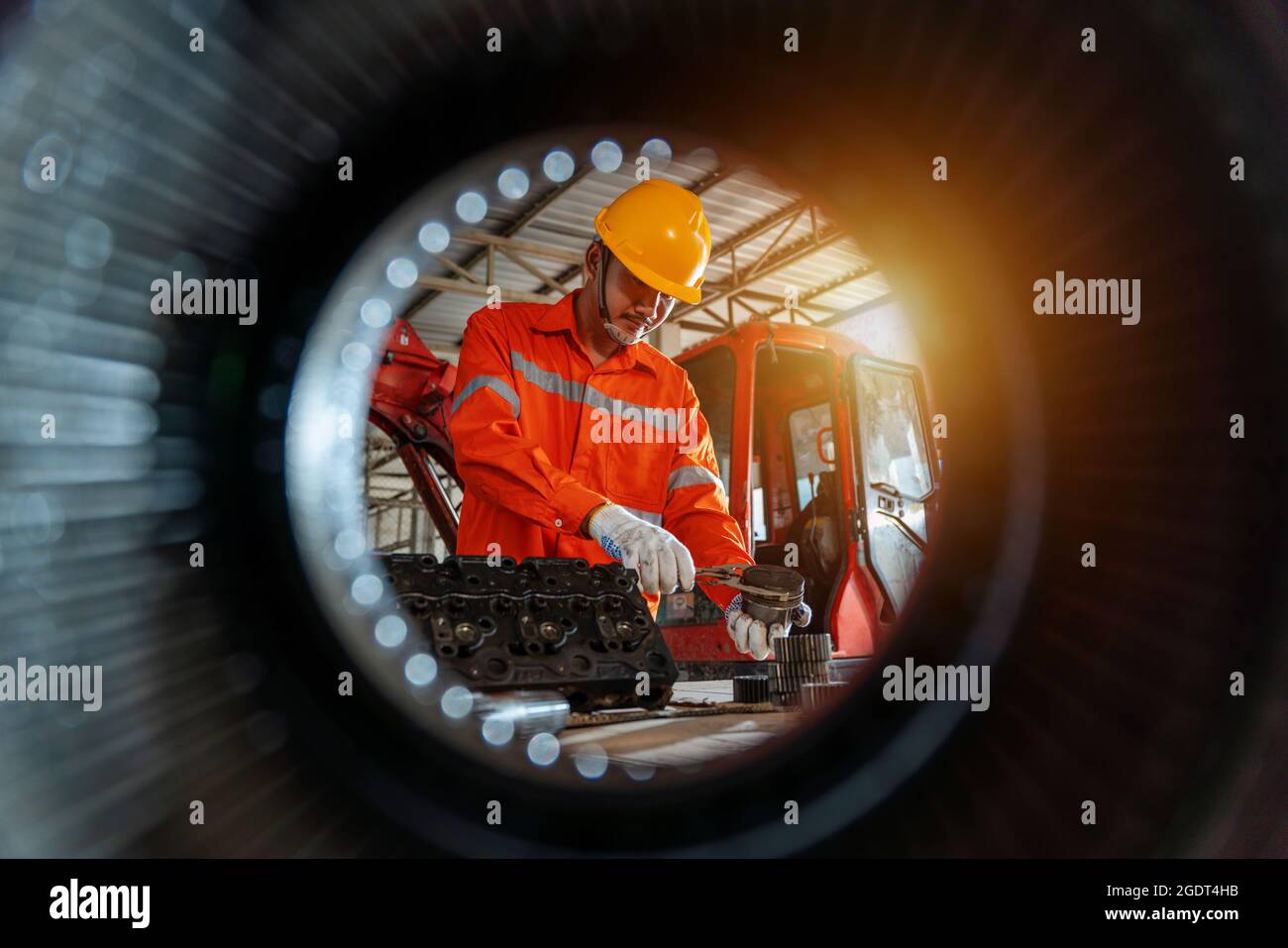 A technician mechanic man holding piston of the hydraulic pump to ...