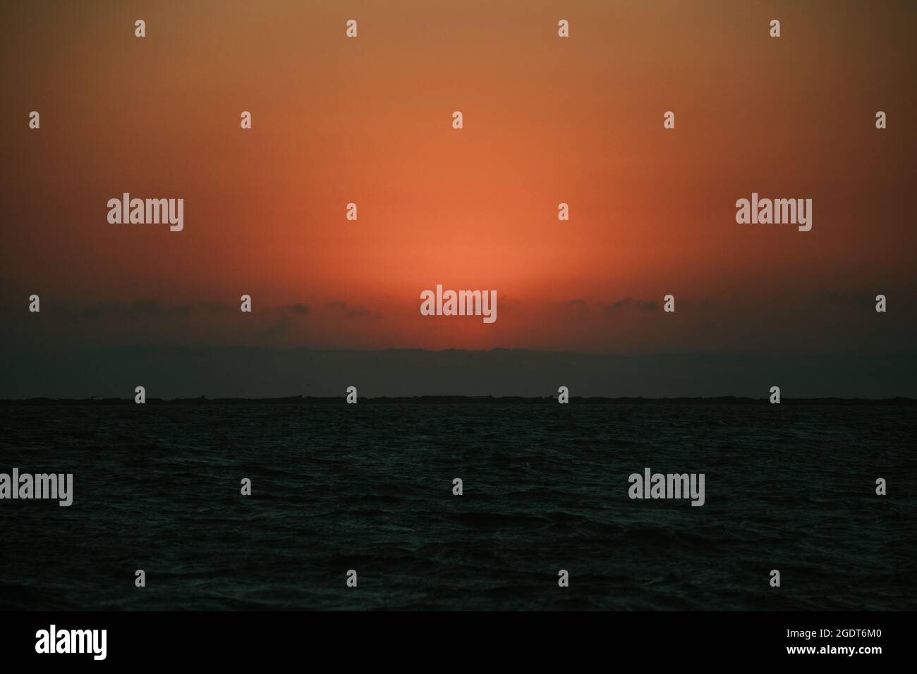 cloudy red sunset over the pacific ocean Stock Photo - Alamy