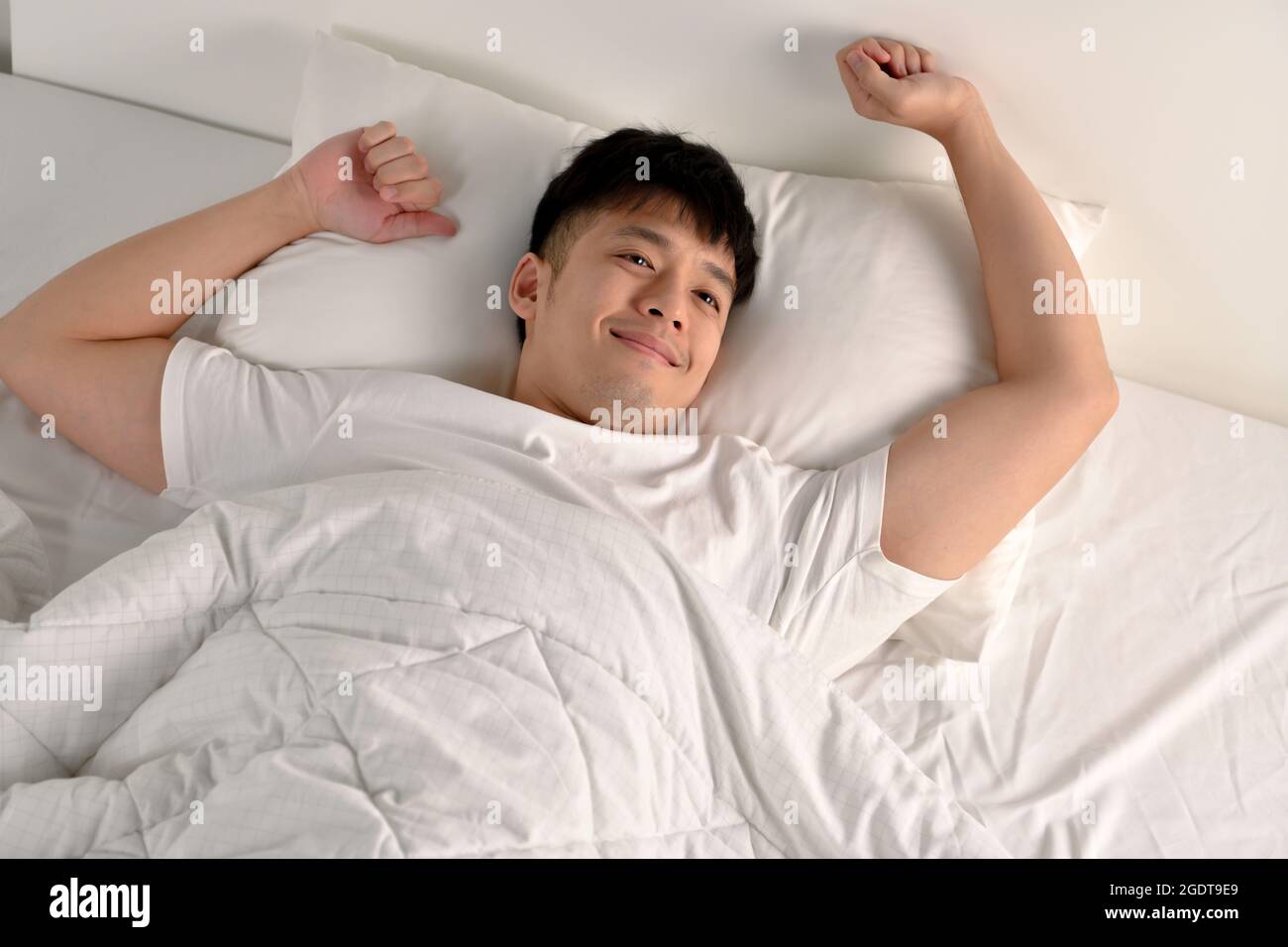 Top view image of happy Asian man waking up in bed in the morning Stock ...