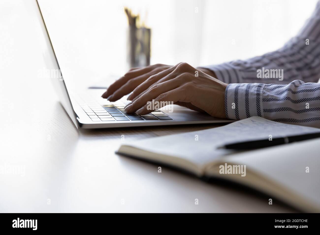 Close up of woman typing on laptop keyboard Stock Photo - Alamy