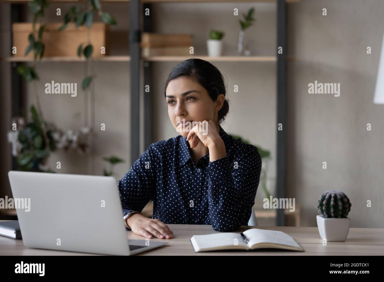 Pensive Indian woman work on laptop thinking Stock Photo - Alamy